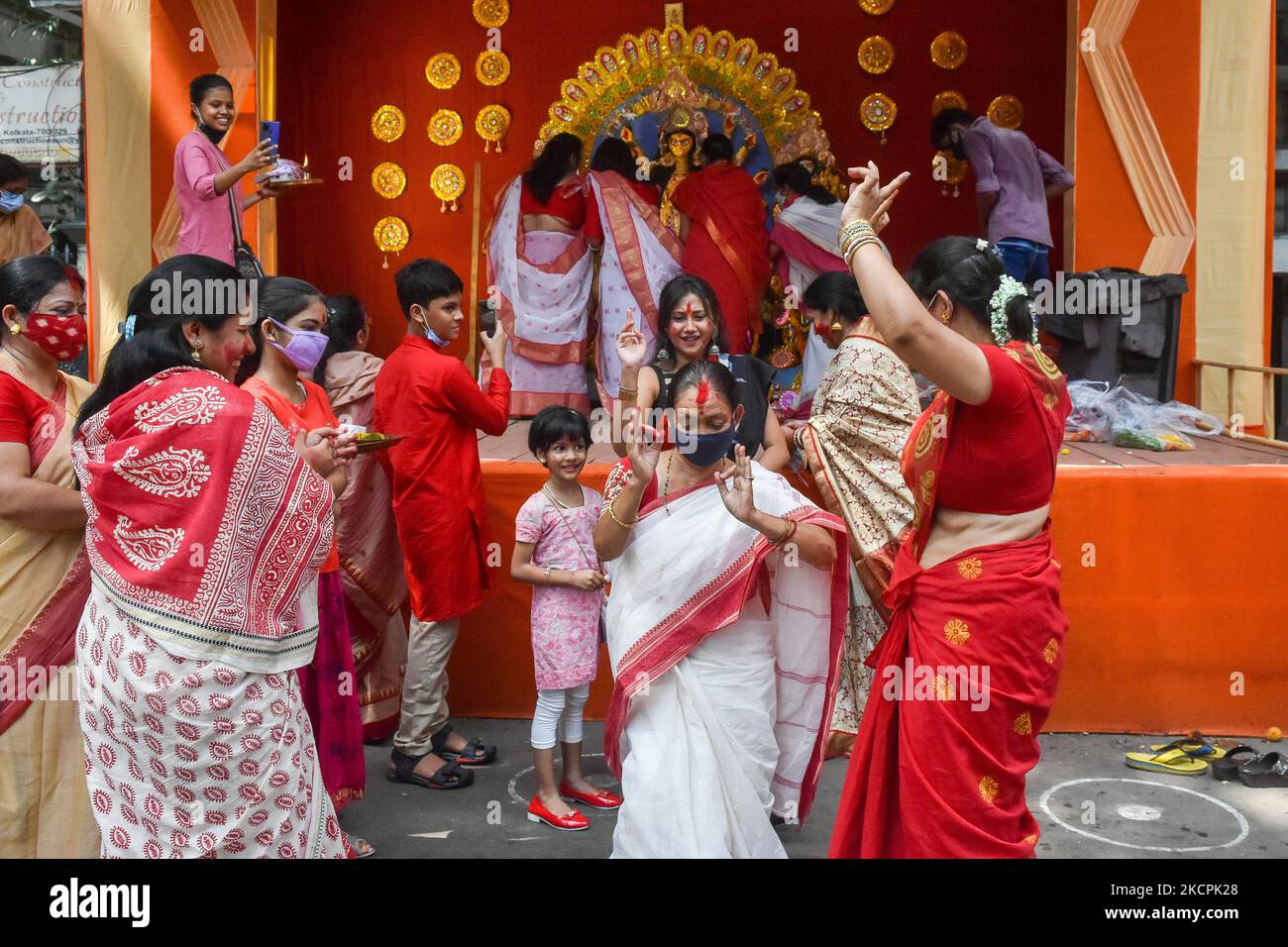 Married ladies smearing red sindur or vermilion , a ritual known as ...