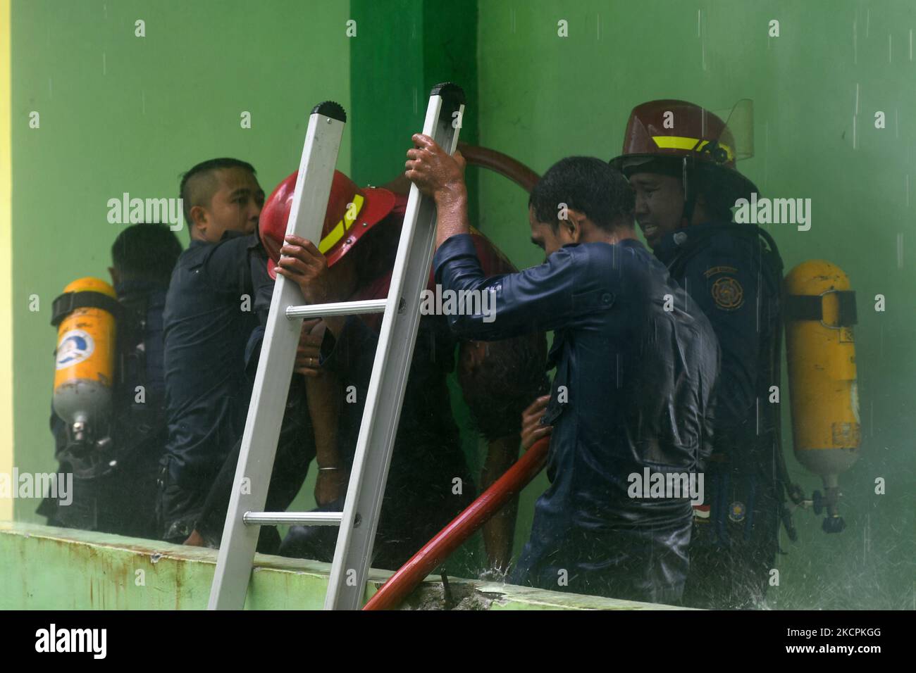 Firefighters carry out an exercise in handling and assisting a high ...