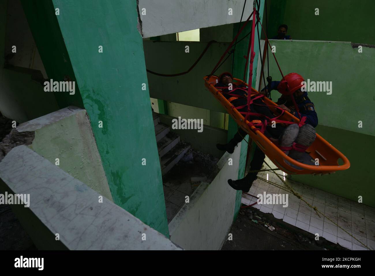 Firefighters carry out an exercise in handling and assisting a high ...