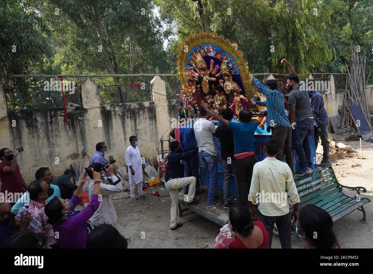 Hindu devotees immerse an idol of Hindu goddess Durga inside a ...