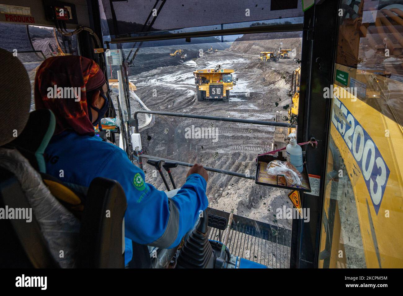 An excavator wait dump truck during over burden activity at a coal mine ...