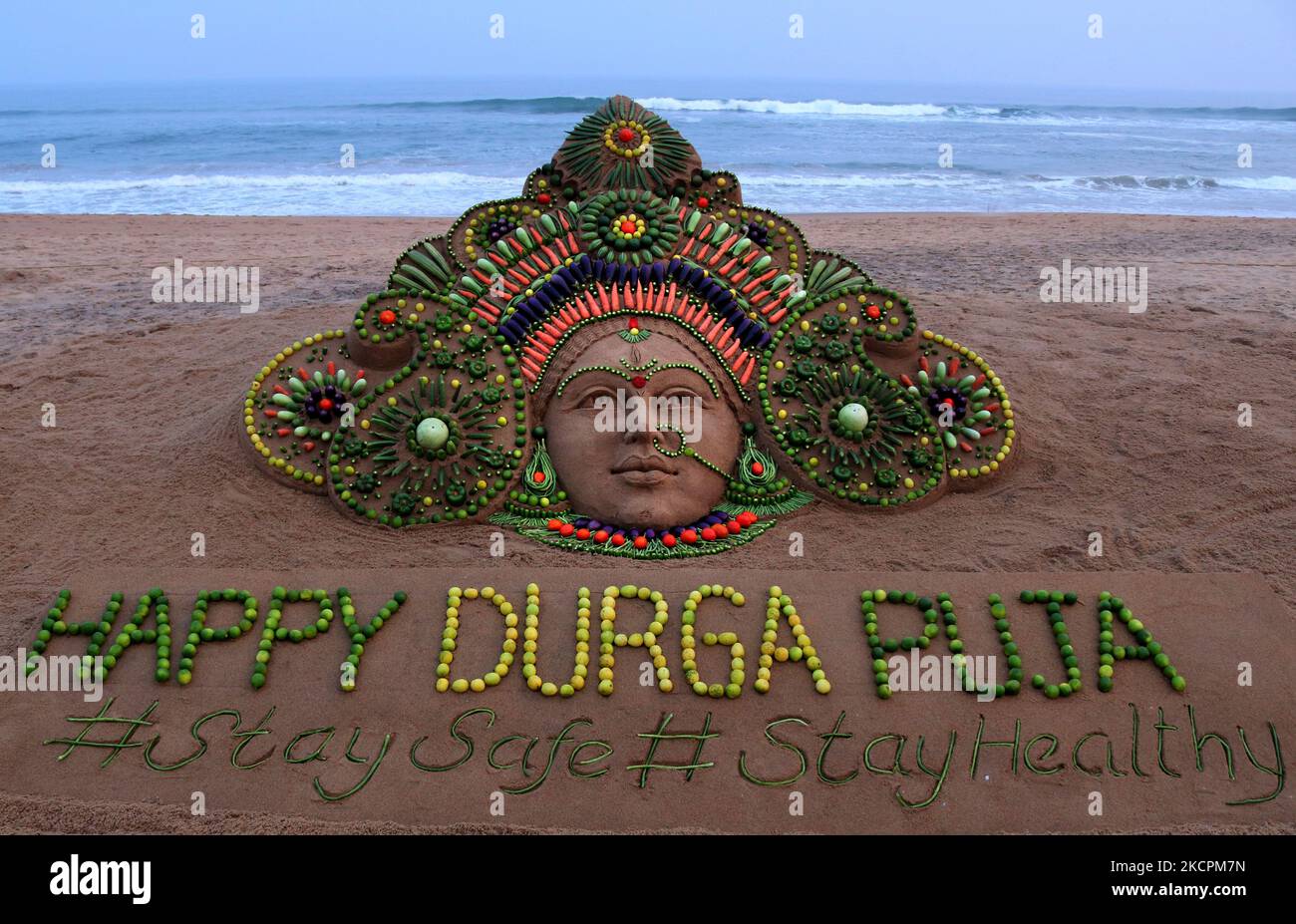 A sand sculpture of Goddess Durga is seen as it is creating by the sand ...