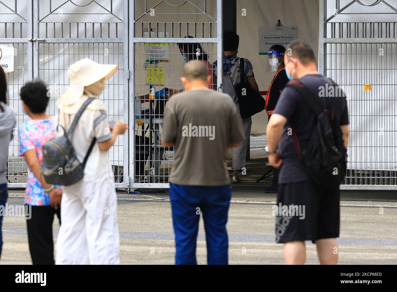 People wearing protective mask wait in queue to take their COVID-19 ...