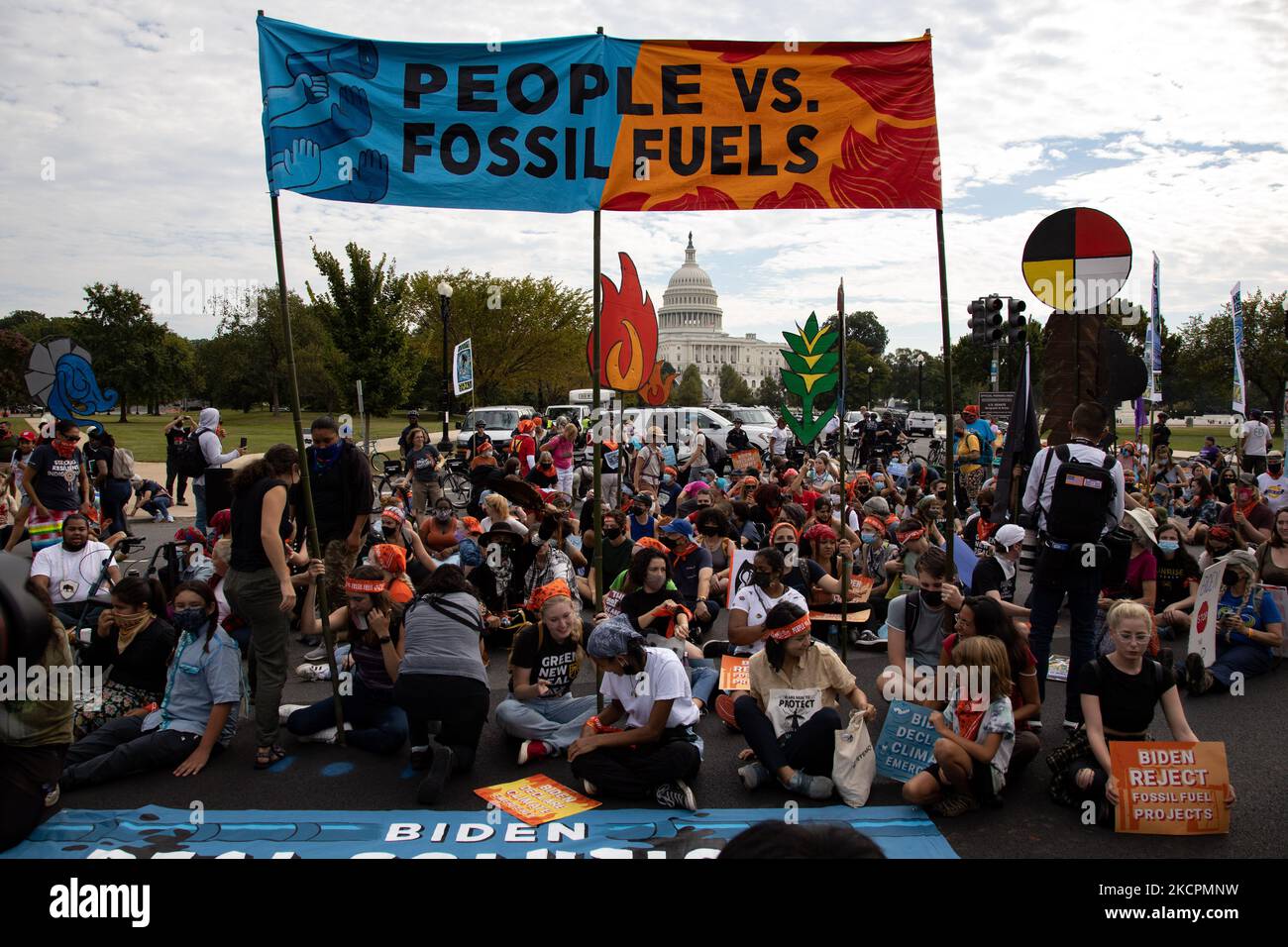 Environmental activists march to the U.S. Capitol on October 15, 2021 ...