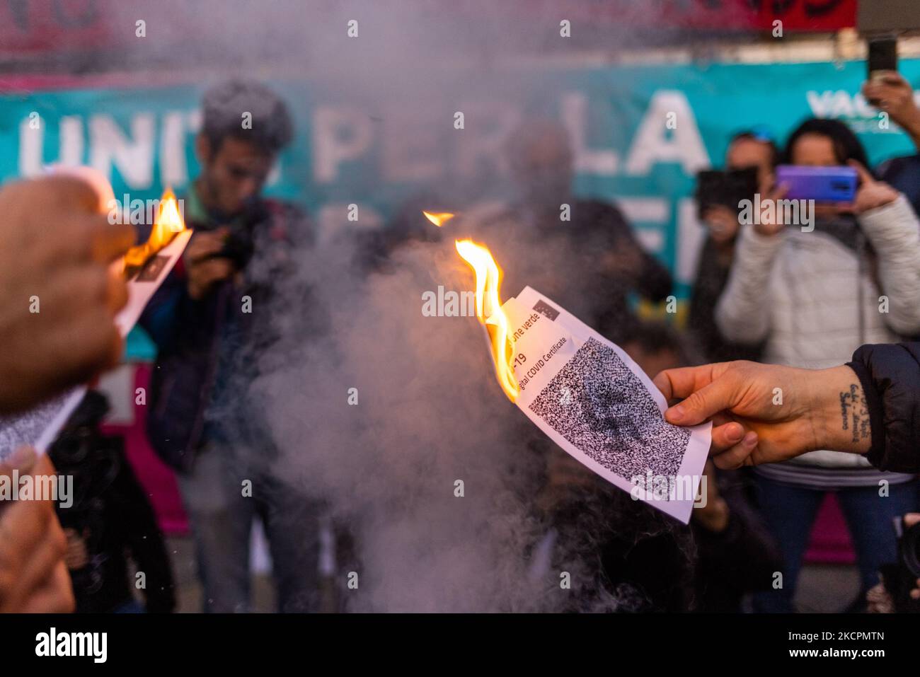 Protesters against the green pass burn facsimiles bearing the swastika ...