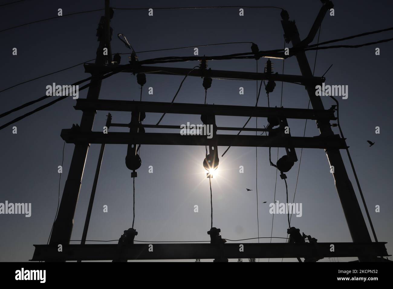 Power lines are installed with an Electricity transformer in Sopore ...