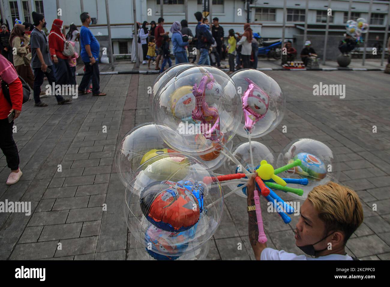 A balloon seller is seen waiting for customers near Gedung Merdeka ...