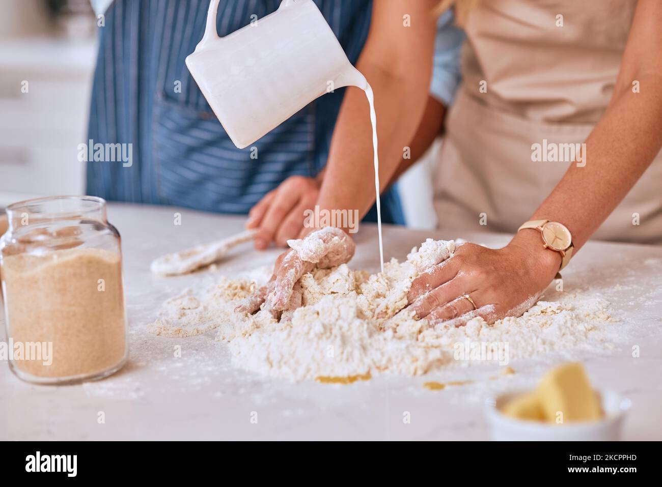 Couple bake together, hands with dough in kitchen, for bonding and ...