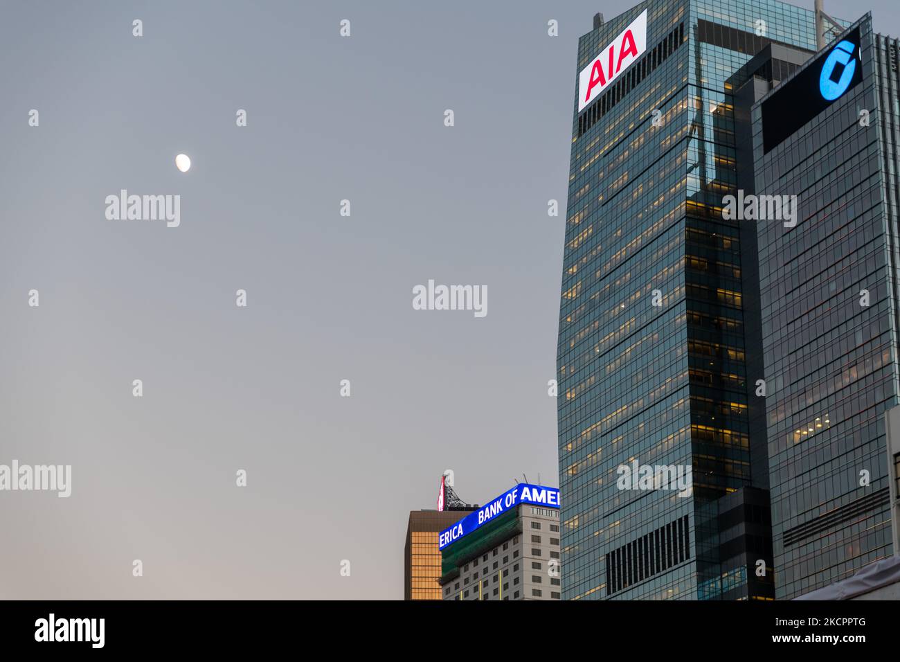 The moon rises as the building of AIA stands in Central Hong Kong ...