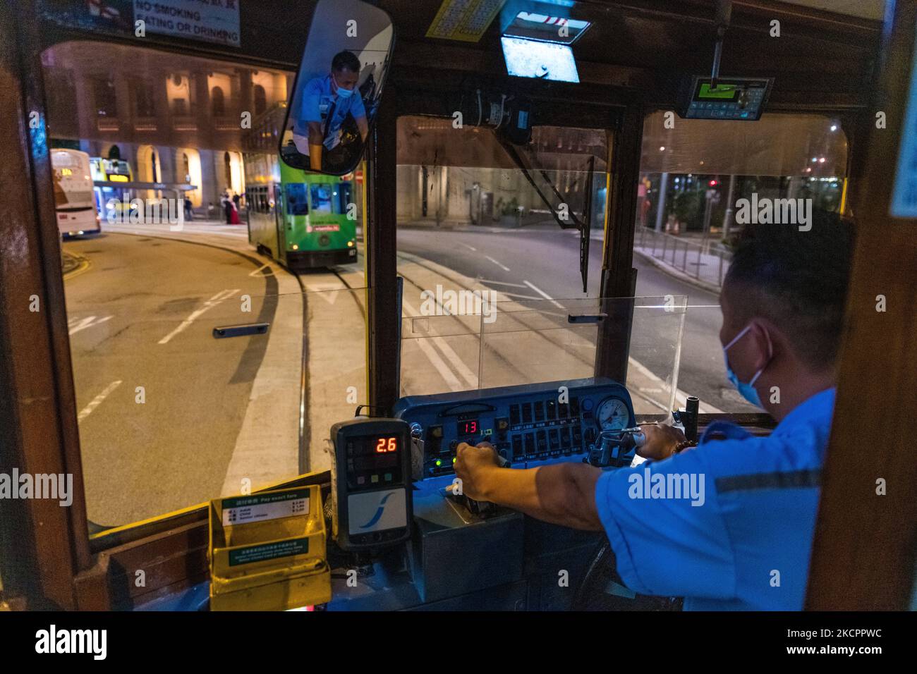 A tram conductor operates his tramway in Central Hong Kong. (Photo by ...