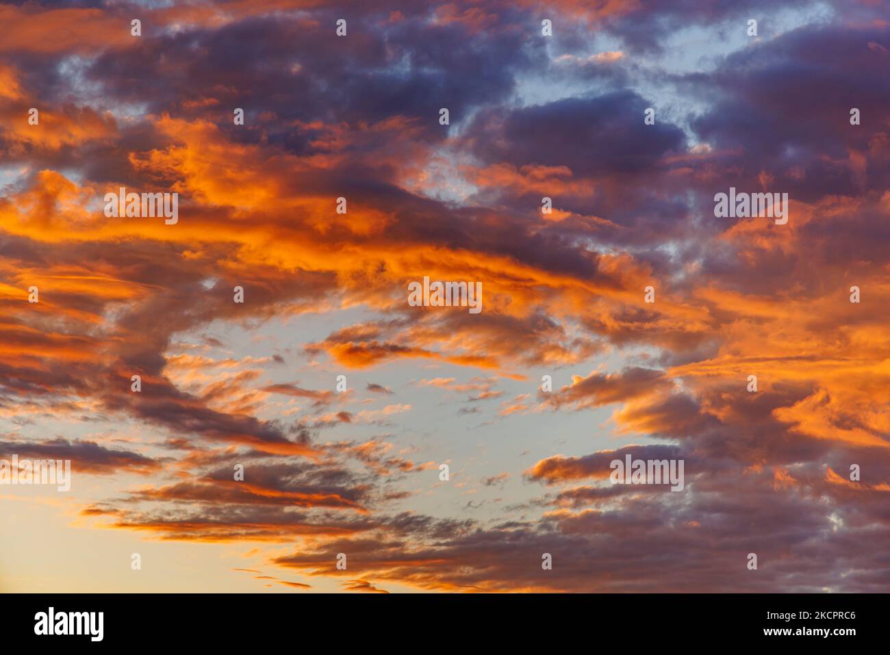 The setting sun lighting up the underside of the cloud cover Stock ...