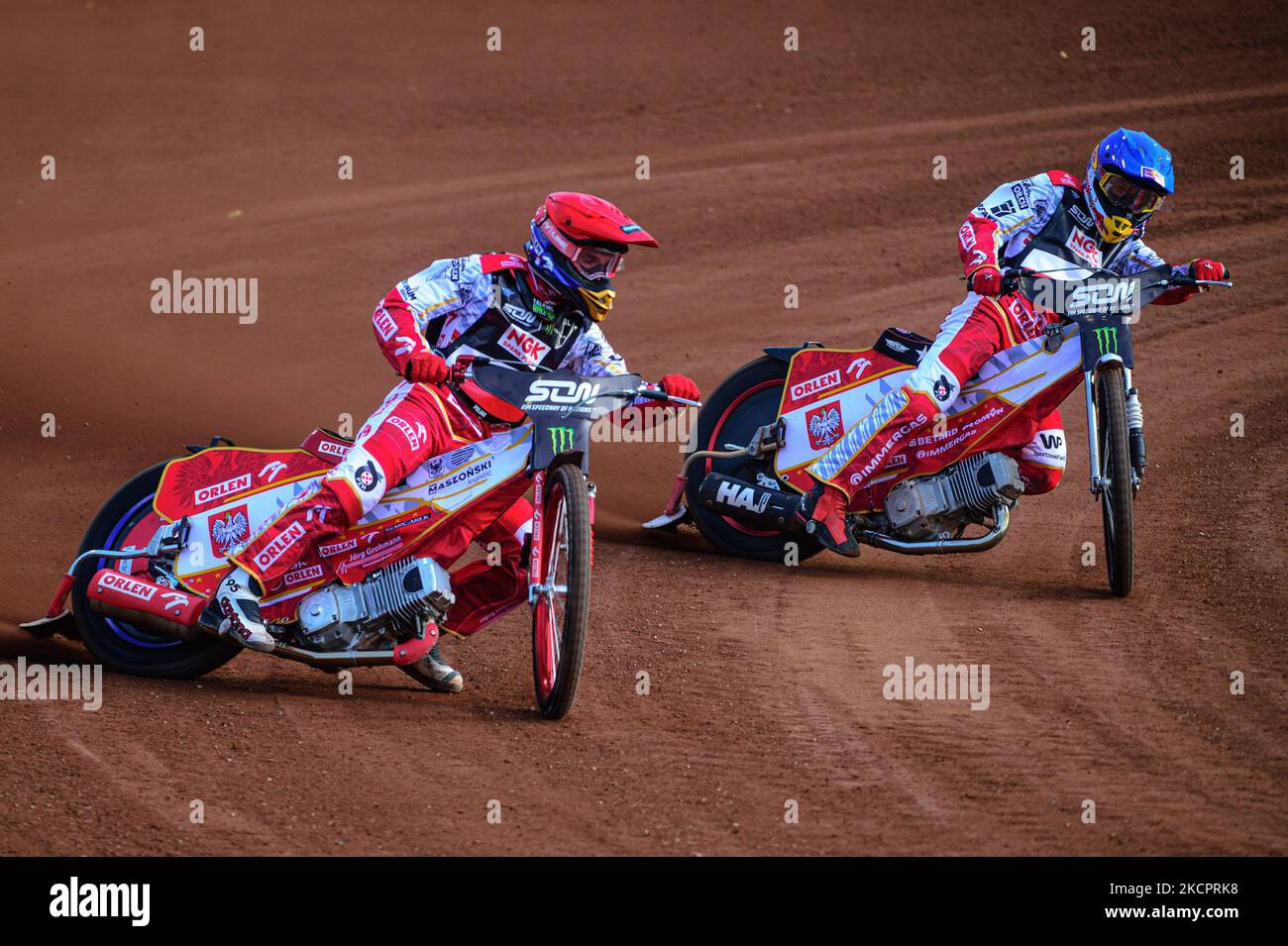 Bartosz Zmarzlik of Poland (Red) looks for team mate Maciej Janowski of ...
