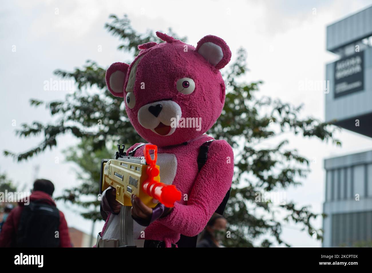 A cosplayer wears a costume of popular battle royale Game Fortnite ...