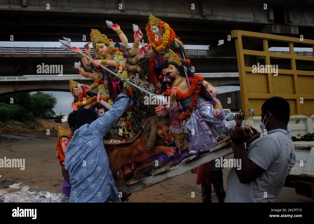 Goddess Durga's idol is seen on the banks of Kuakhai River as devotees ...