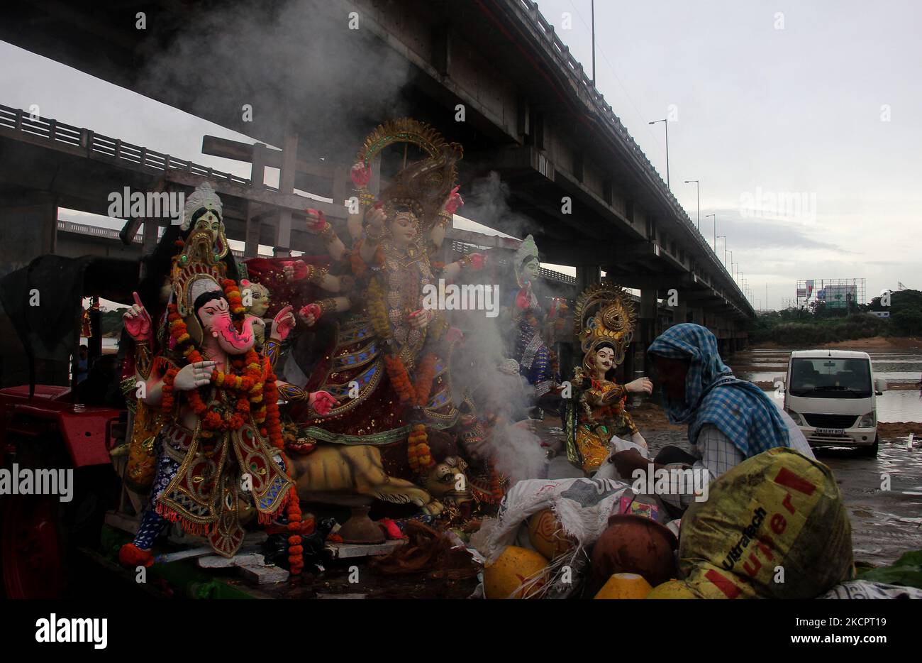 Goddess Durga's idol is seen on the banks of Kuakhai River as devotees ...