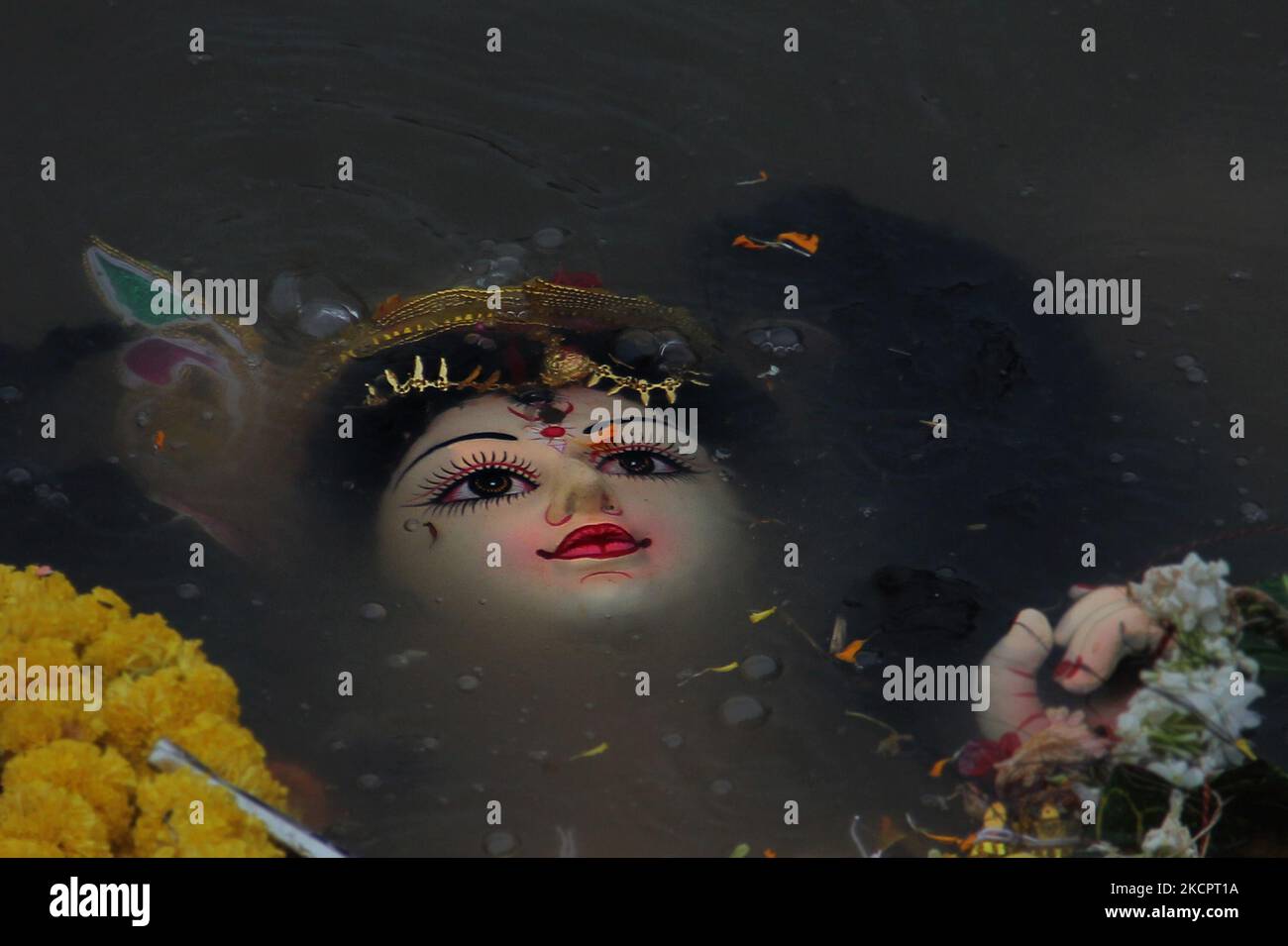 Goddess Durga's idol is seen before sinking into the water after ...