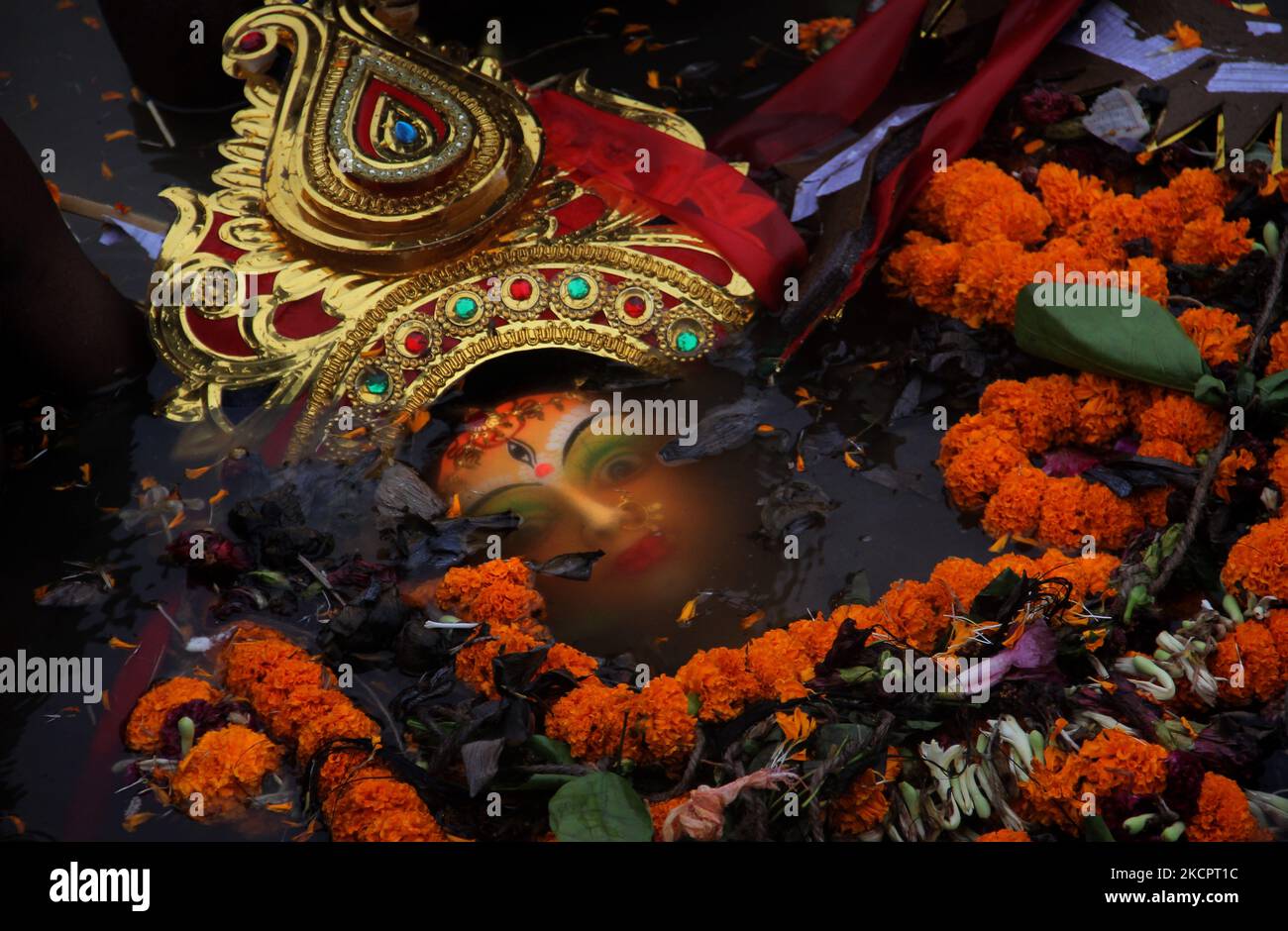 Goddess Durga's idol is seen before sinking into the water after ...