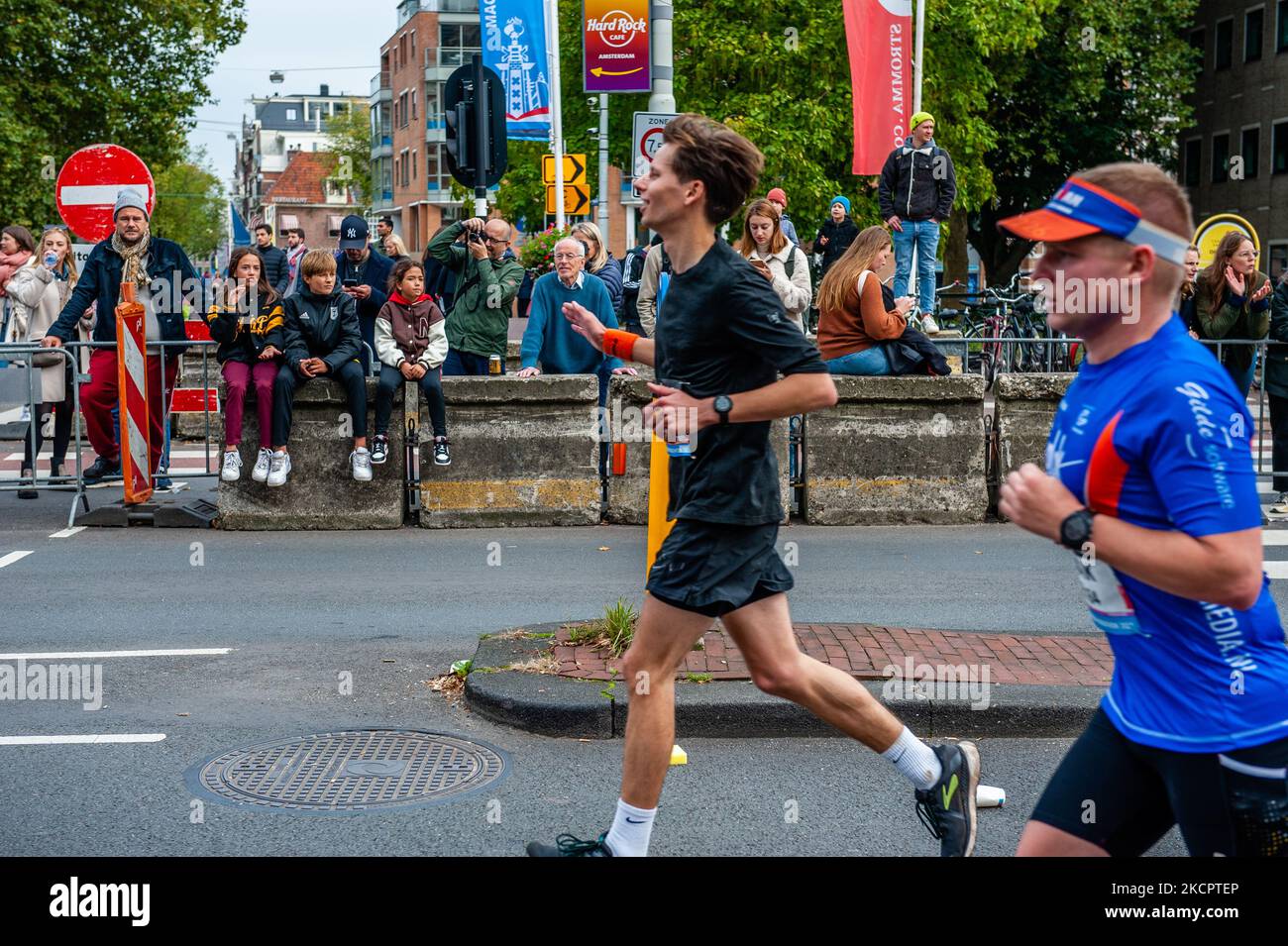 A group of children are watching the runners, during the last ...