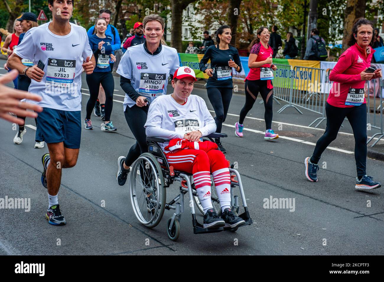 A woman is running with a woman on a wheelchair, during the TCS ...