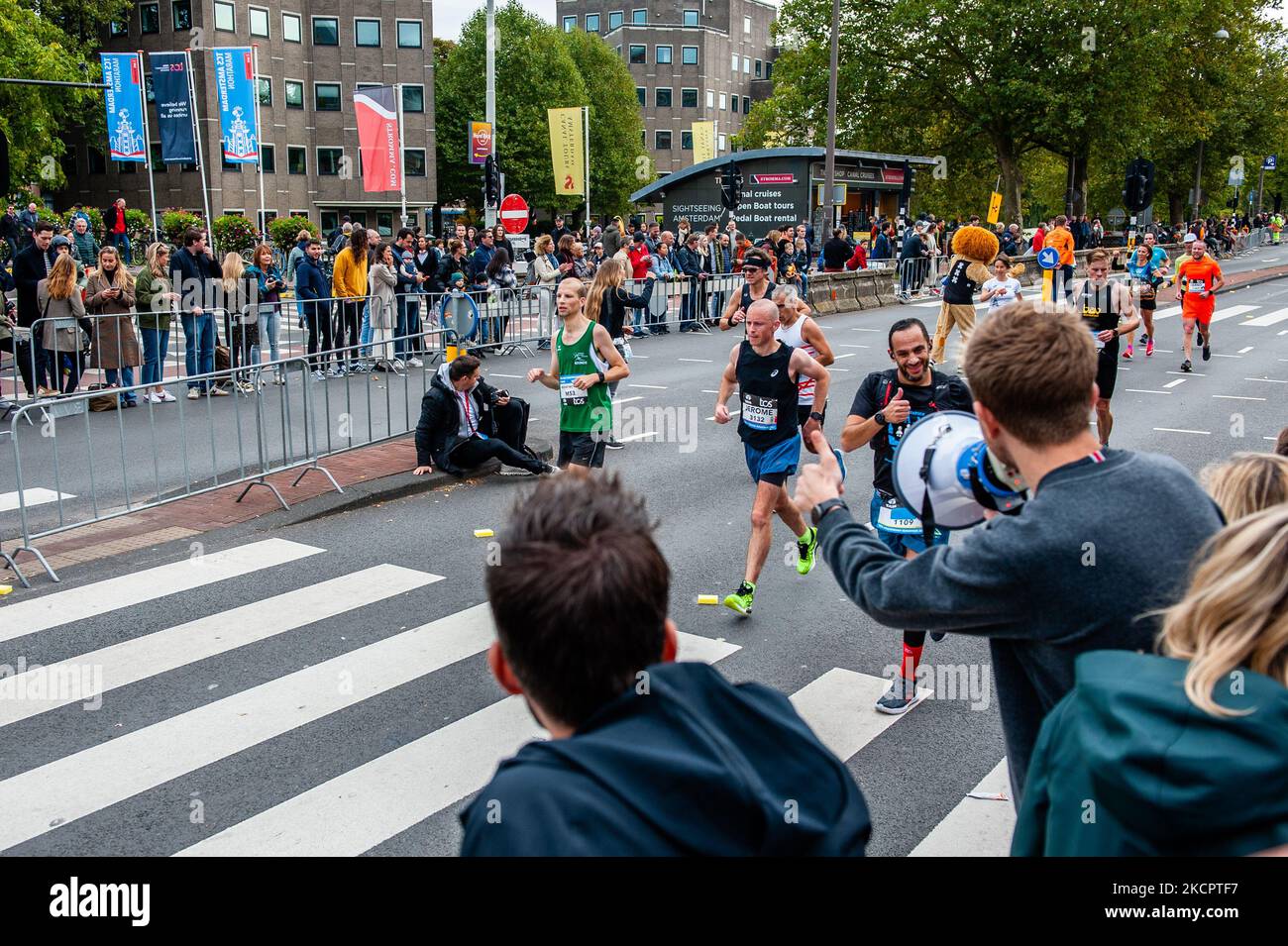 Spectators are cheering to the runners, during the last kilometers of ...