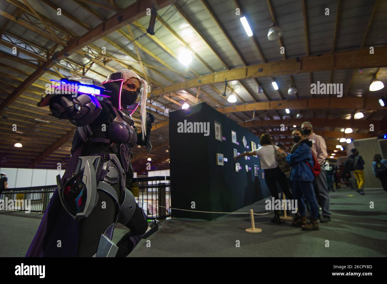 A League of Legends fan poses for a photo using a costume inspired by a ...