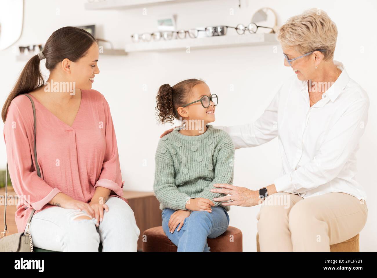 Optometry, glasses and vision with a girl, mother and optician meeting ...