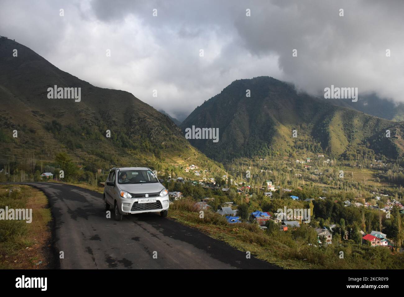 A man drives a car on the hills of zabarwan mountain range in Srinagar ...