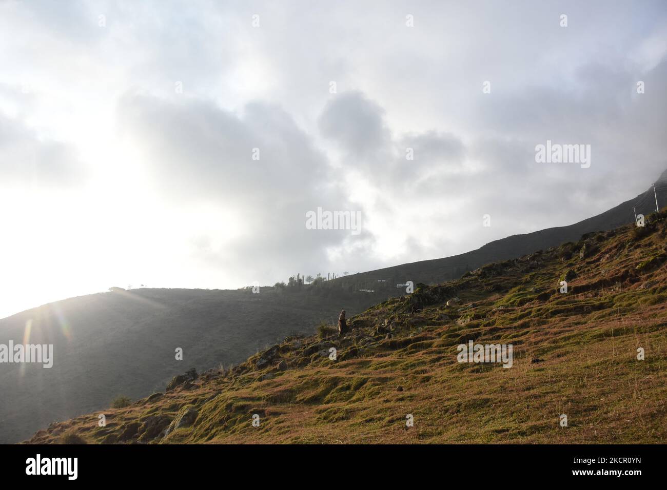 People walk on the zabarwan mountain range in Srinagar, Indian ...