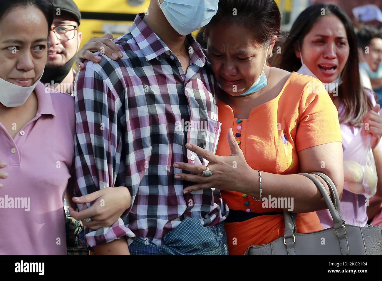 A released prisoner reunites with his family outside Insein prison in ...