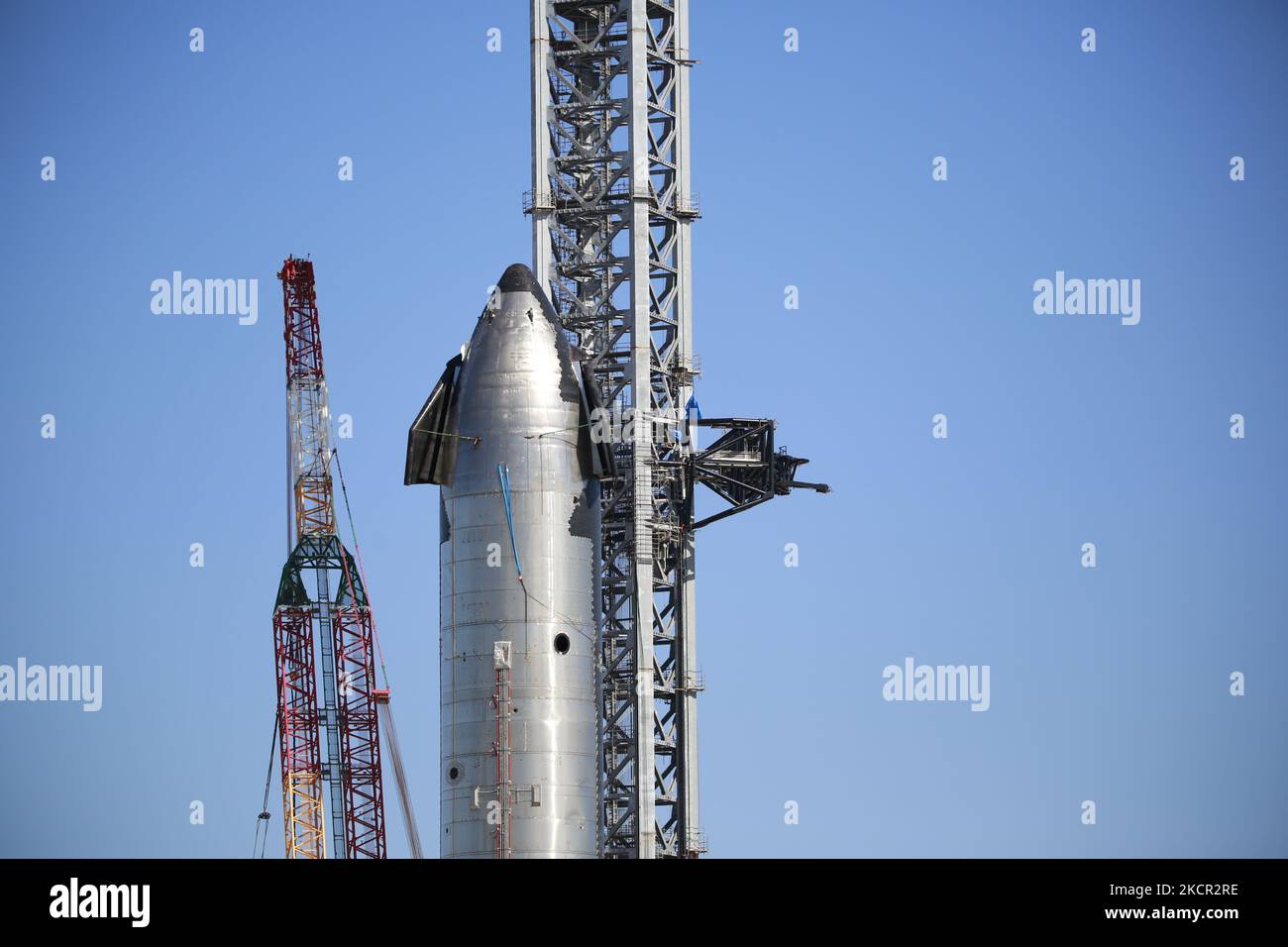 Starship 20 stands in font of the nearly completed launch tower on ...