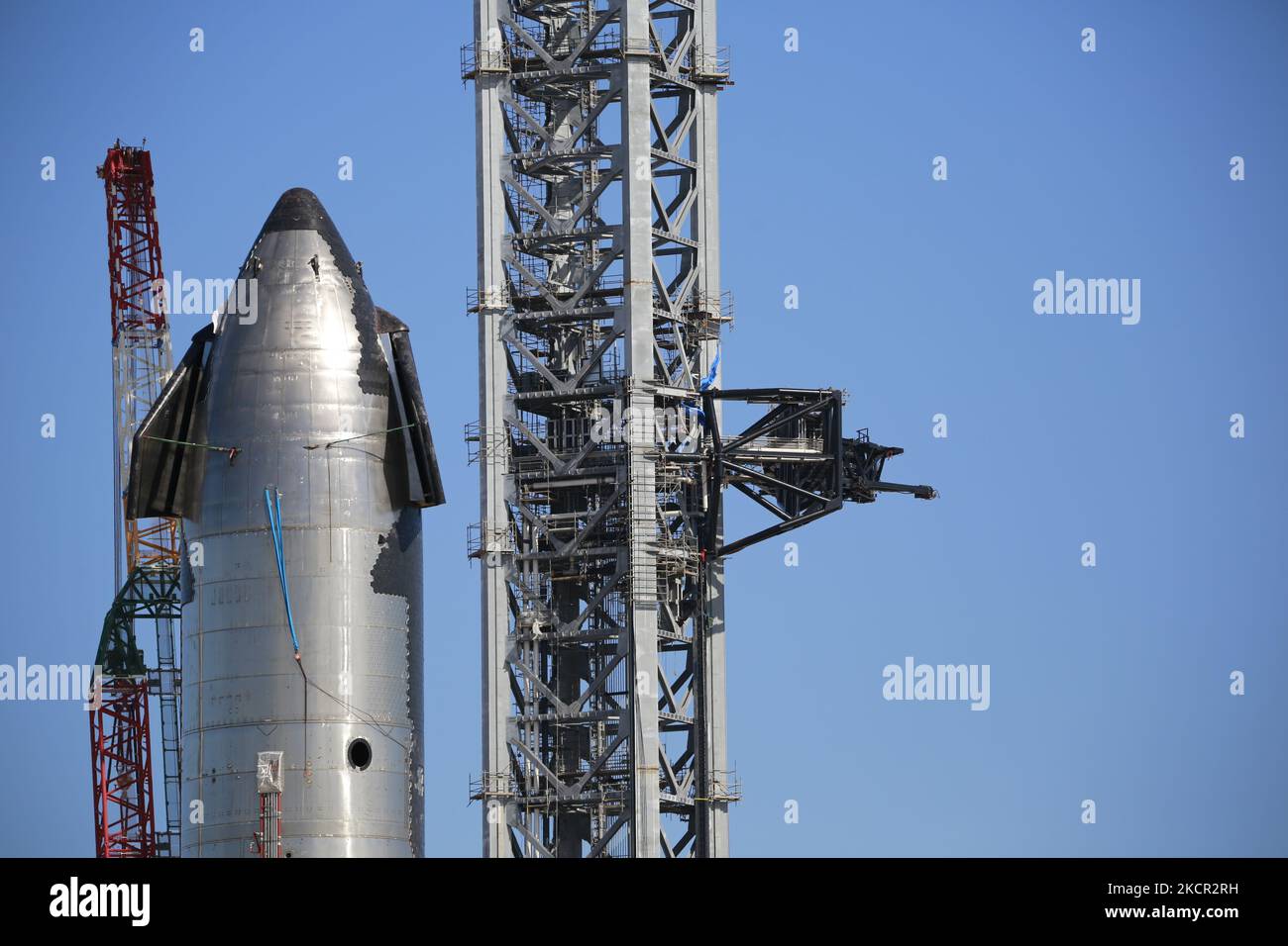 Starship 20 stands in font of the nearly completed launch tower on ...