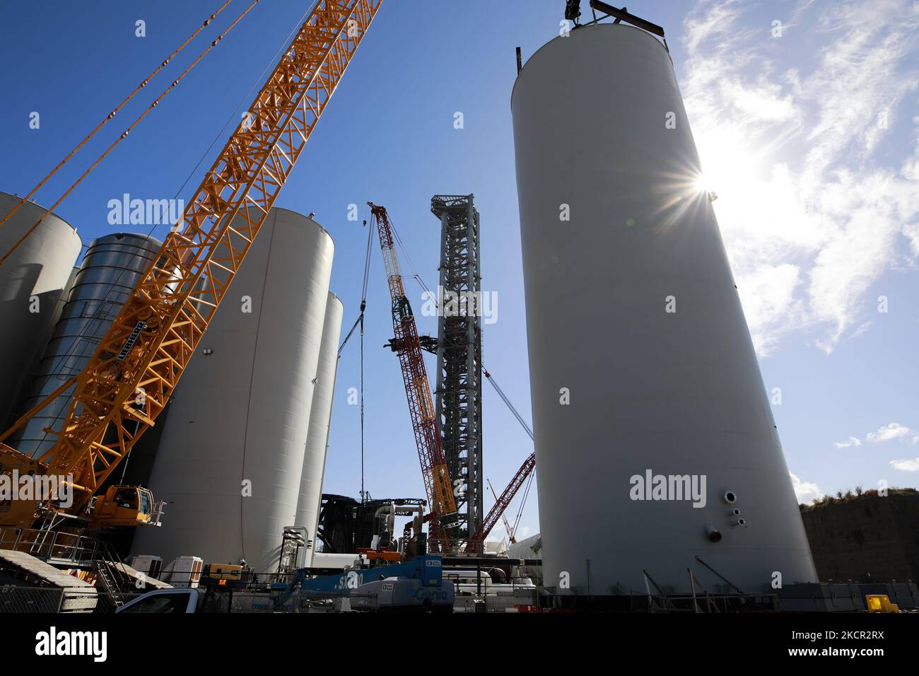 The nearly finished Starship launch tower is seen behind the tank farm ...
