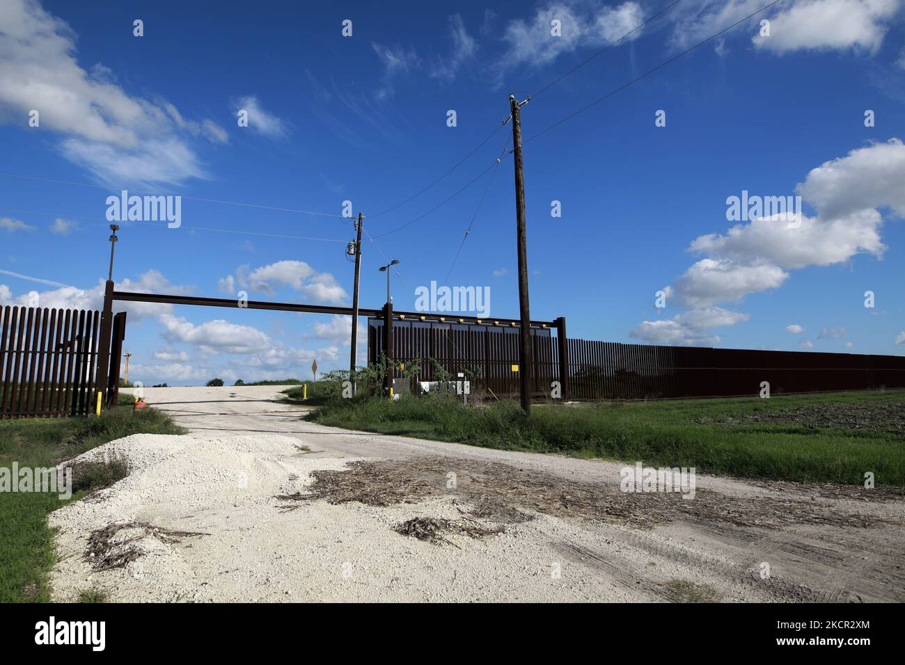 An opened gate in the U.S.-Mexican border wall in Cameron County, Texas ...
