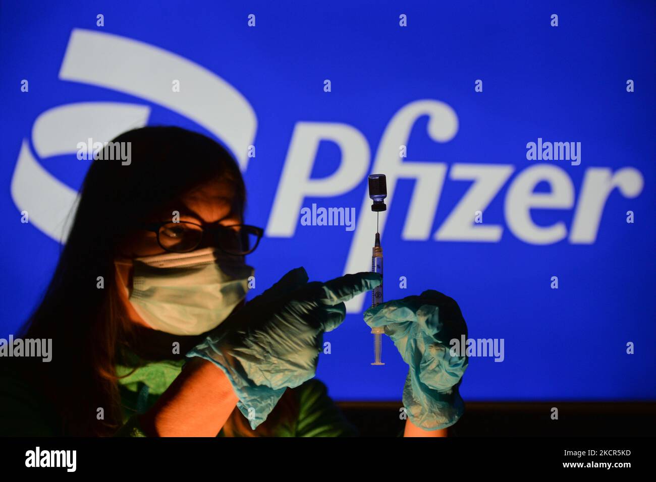 An illustrative image of a person holding a medical syringe and a ...