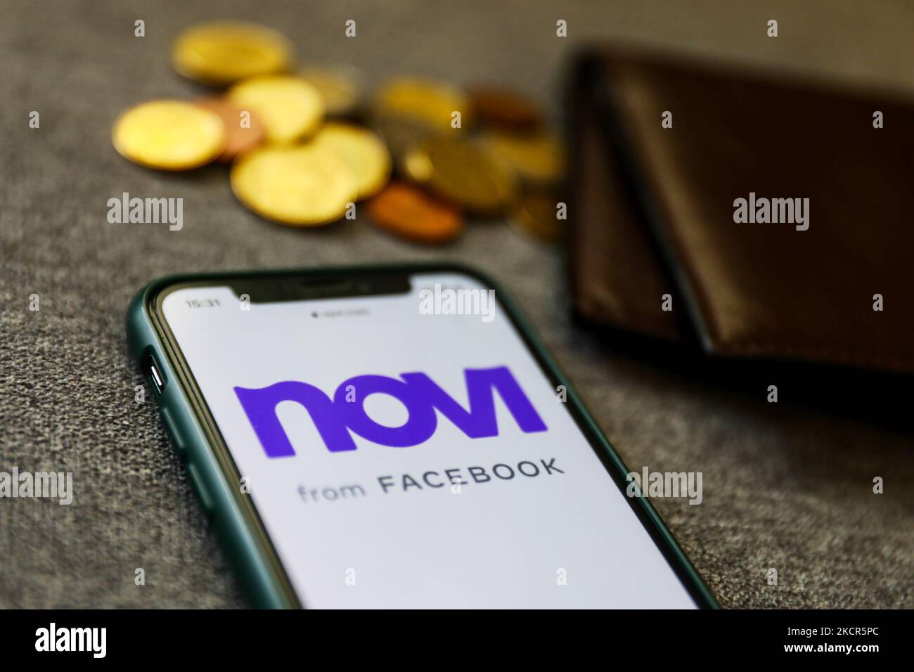 Novi logo displayed on a phone screen is seen with coins and a wallet ...