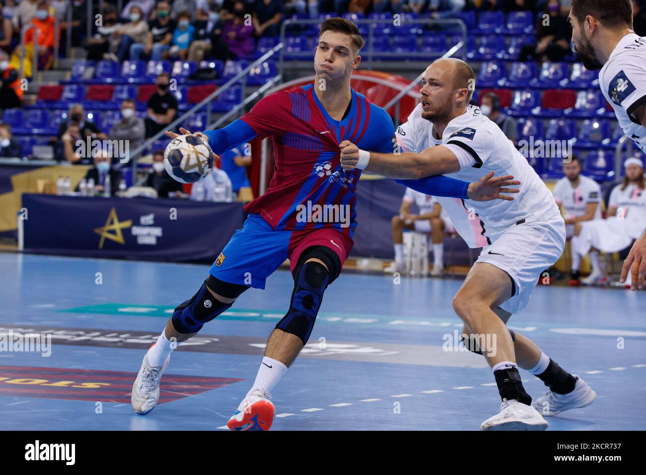 Domen Makuc of FC Barcelona in action with Henrik Toft Hansen of PSG ...