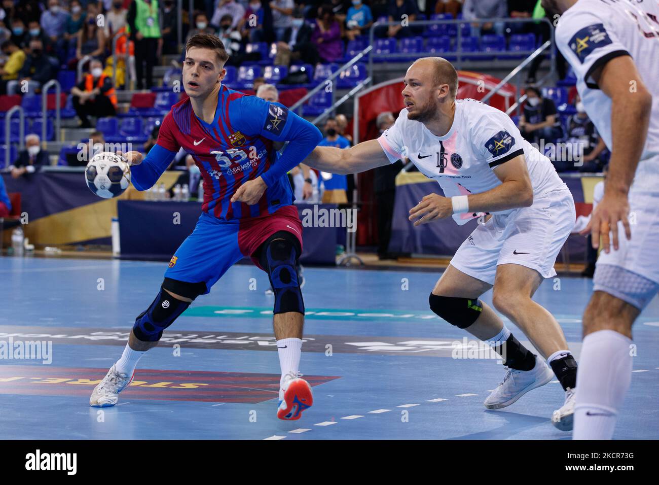 Domen Makuc of FC Barcelona in action with Henrik Toft Hansen of PSG ...