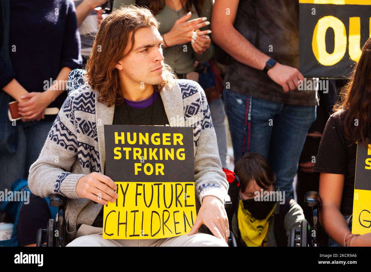 Hunger strikers hold signs with the reason(s) they are striking at a ...