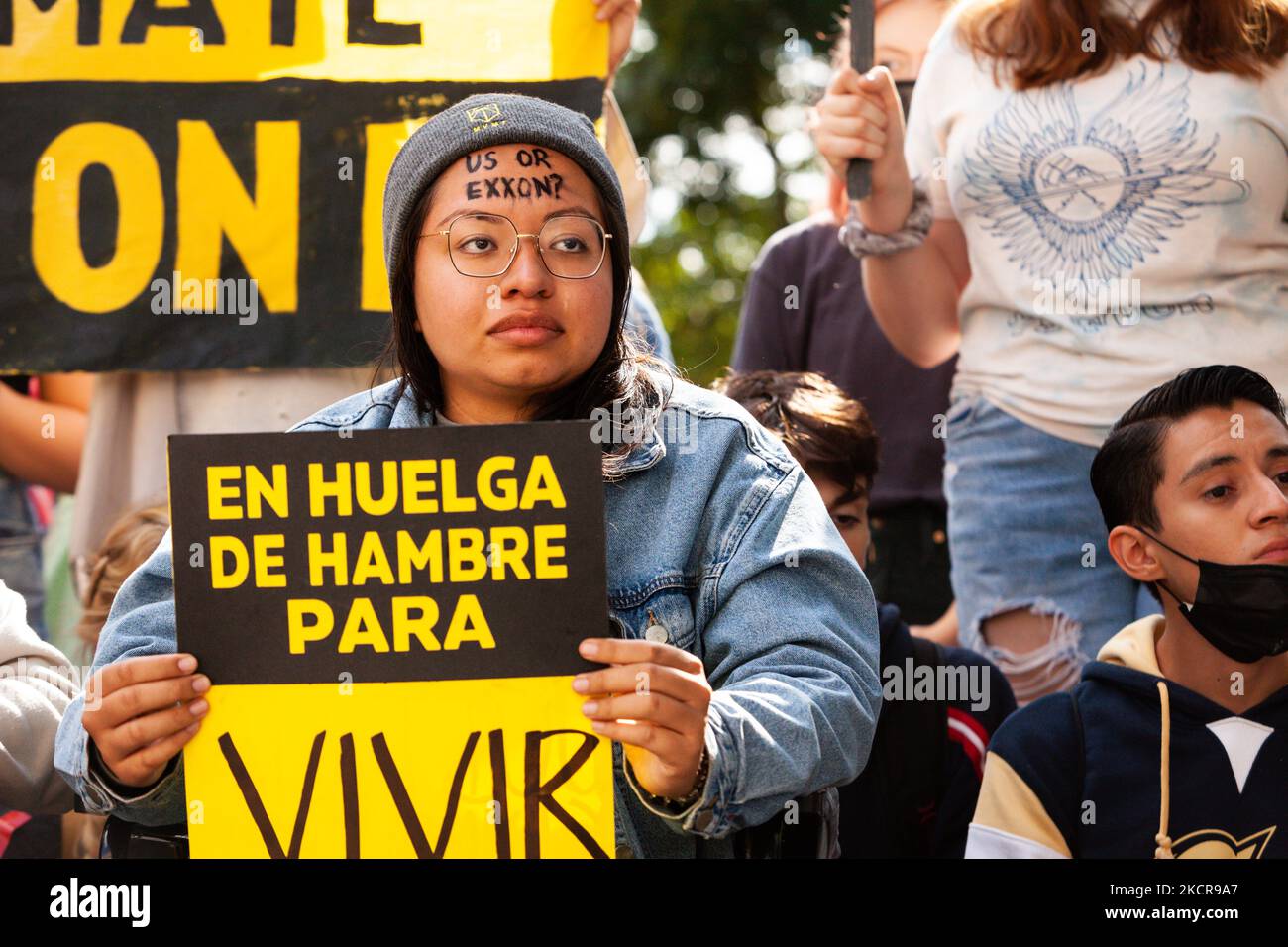 Hunger strikers hold signs with the reason(s) they are striking at a ...