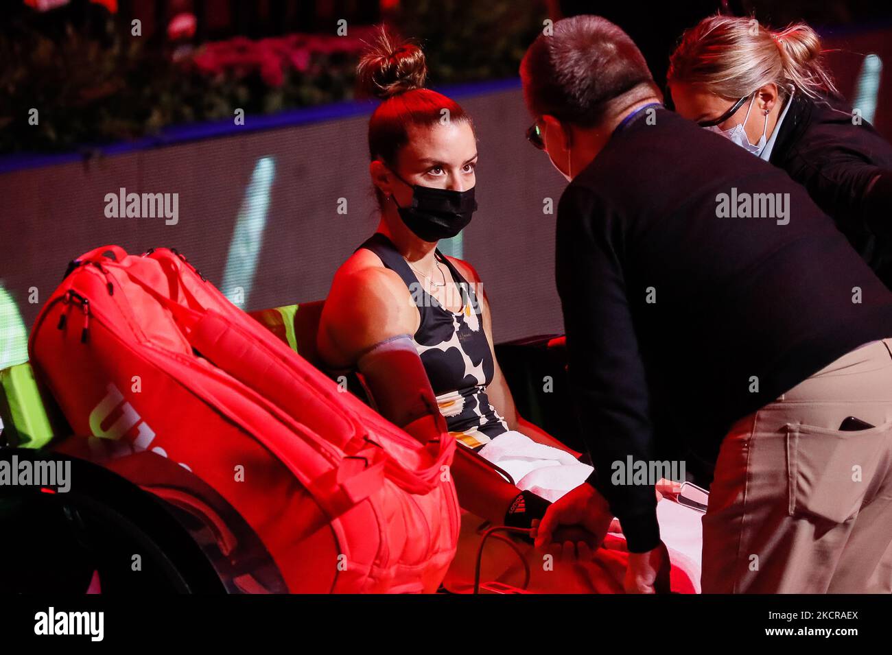 Maria Sakkari (C) of Greece gets medical attention during the women's ...