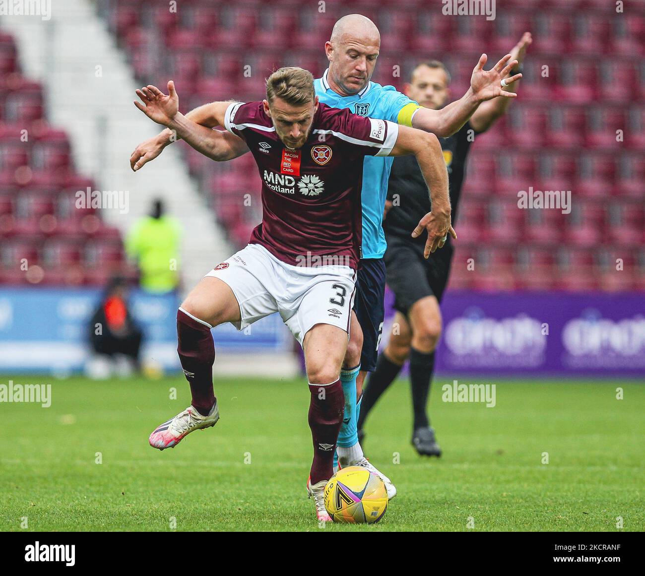 Stephen Kingsley of Hearts and Charlie Adam of Dundee compete for the ...