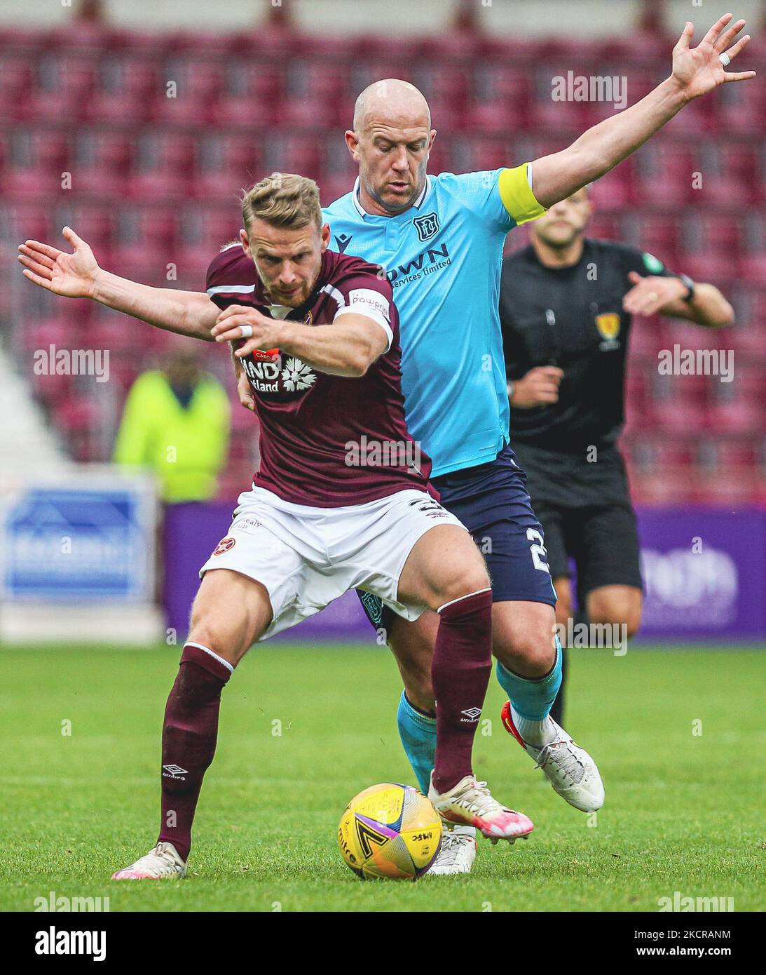 Stephen Kingsley of Hearts and Charlie Adam of Dundee compete for the ...