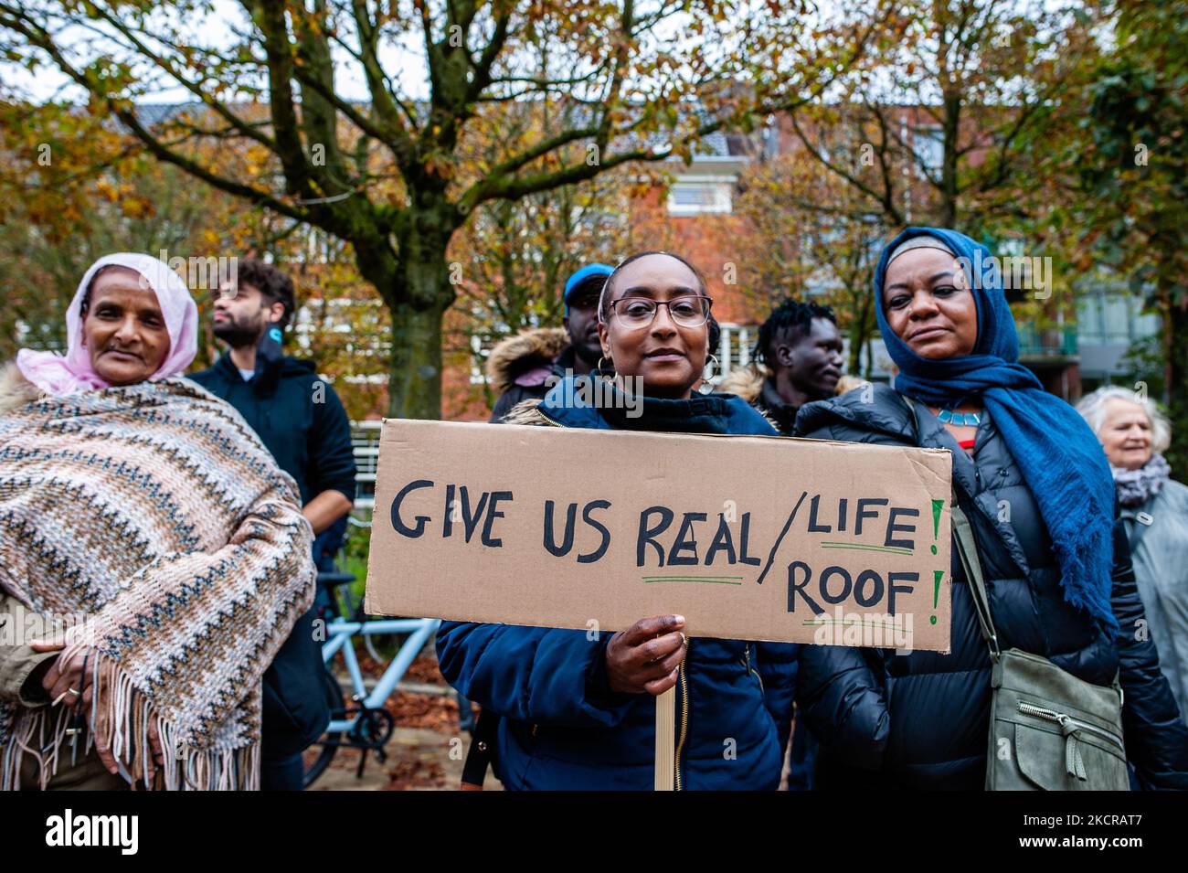 An undocumented woman is holding a placard asking for a solution ...