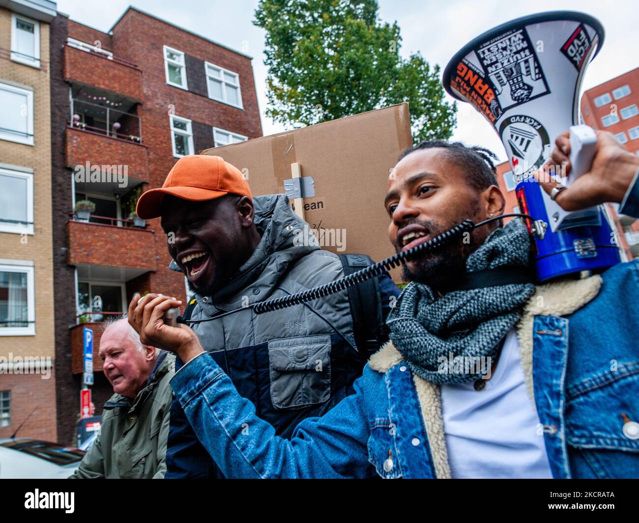 An undocumented Black man is shouting slogans in support of refugees ...