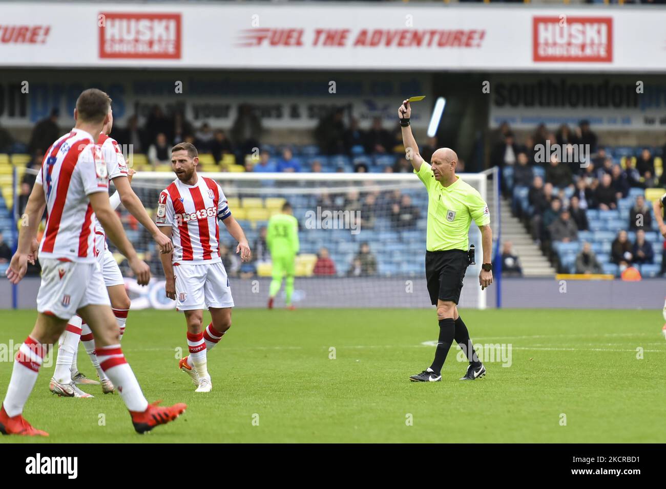 Joe Allen of Stoke City is shown a yellow card by the referee Andy ...
