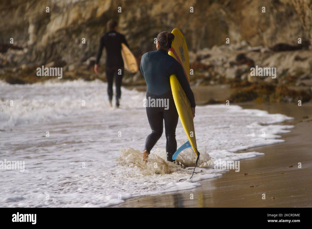 Surfers are seen surfing in the early morning hours. Saturday, October ...