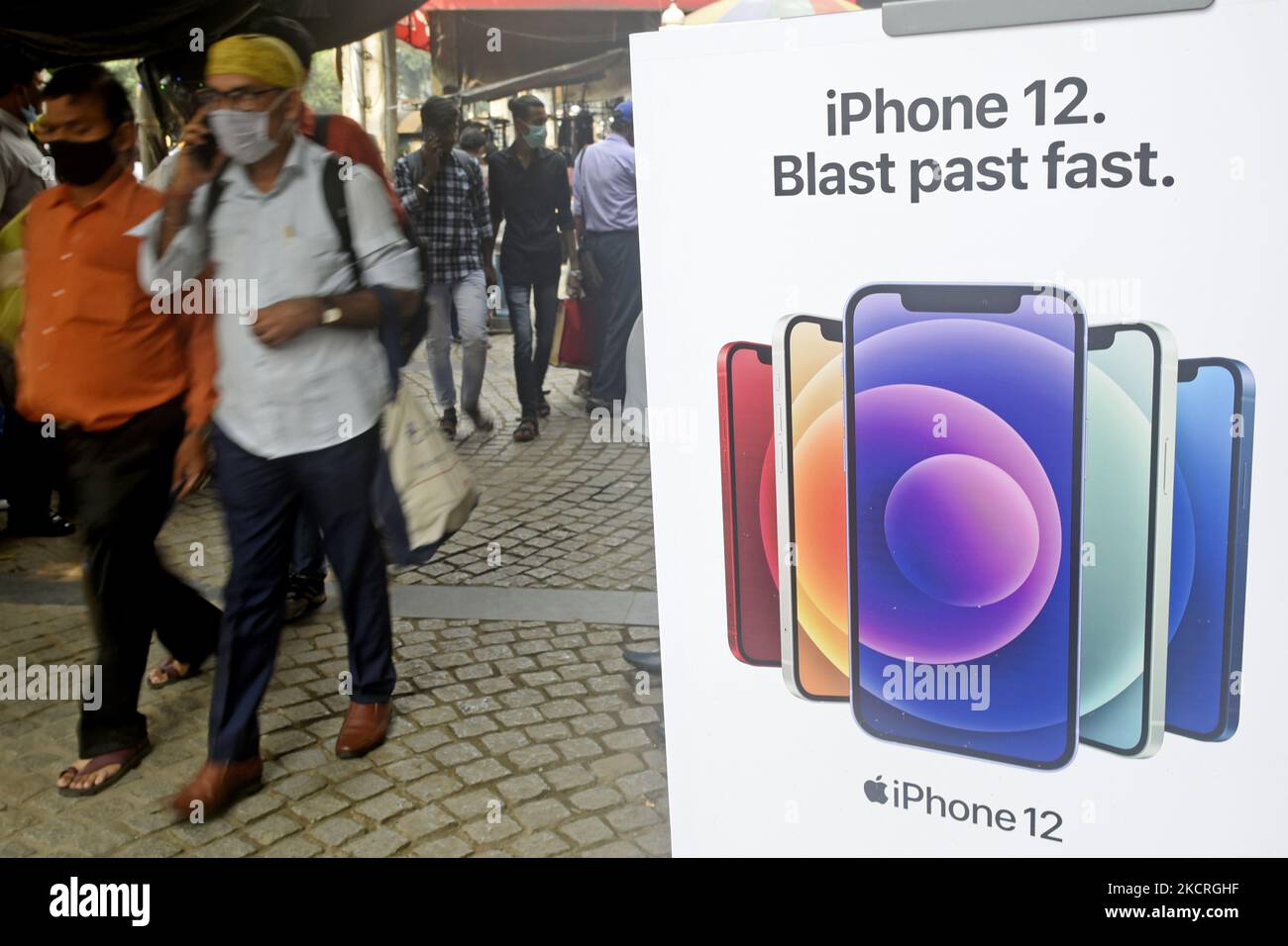 People walk past an iphone advertisement in Kolkata, India, 25 October ...