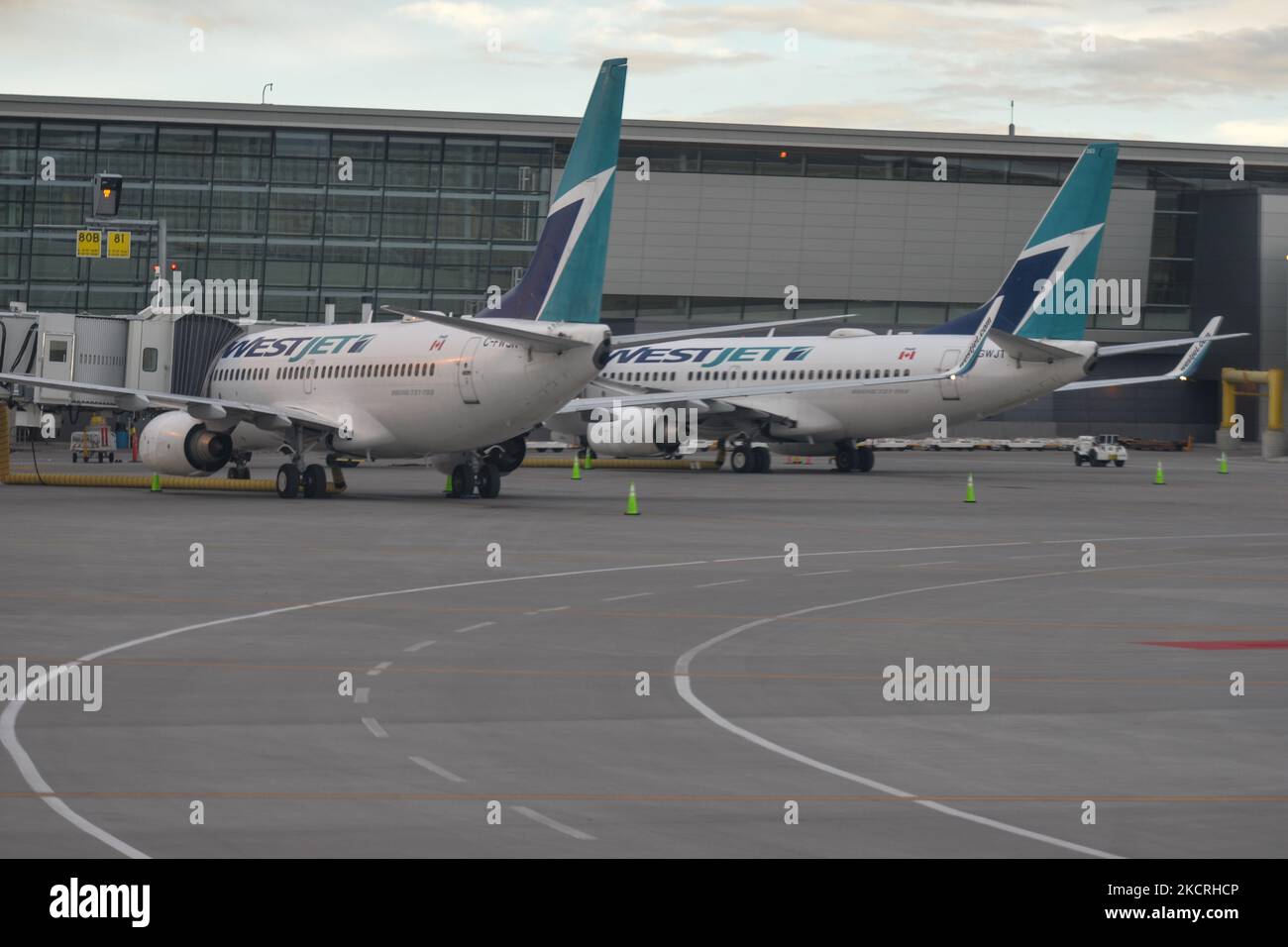 WestJet Airlines planes seen at YYC Calgary International Airport. On ...