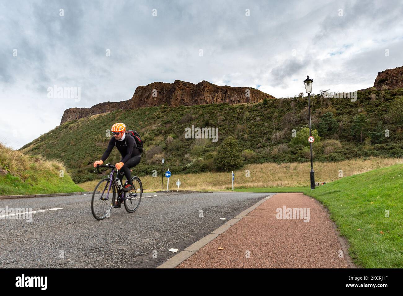 Tourists cycles in front of Hollyrood Park as autumn weather with ...