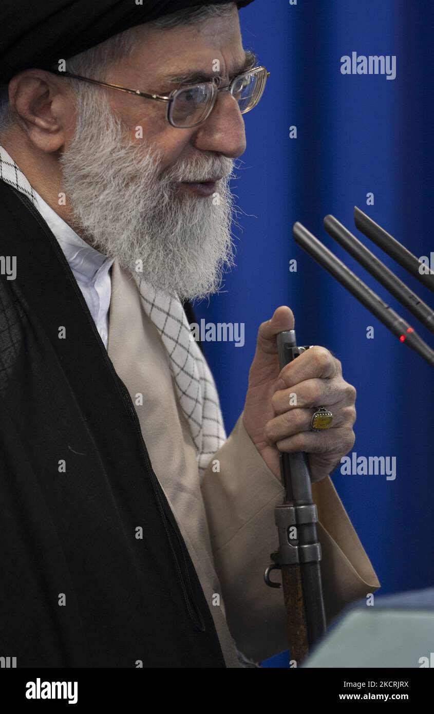 Iran's Supreme Leader Ayatollah Ali Khamenei holds a gun as he speaks ...